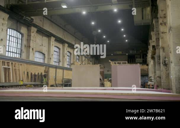 WS Crane moving large prefab building parts inside warehouse, England ...