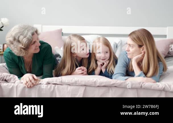 Three generations of women laying on the bed Stock Video Footage - Alamy
