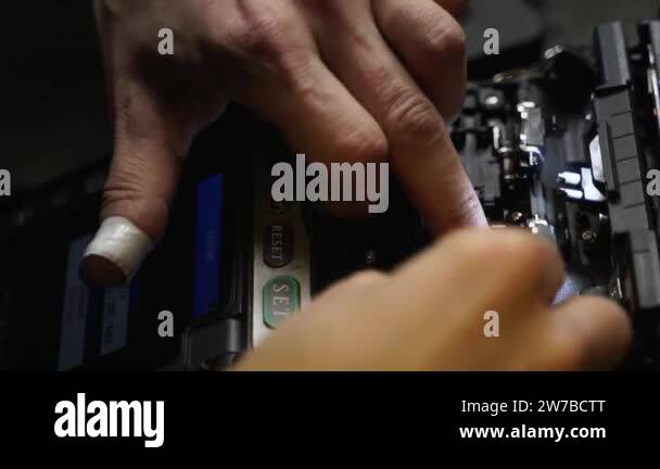 Worker welds optical line internet wire with welding machine. Service ...