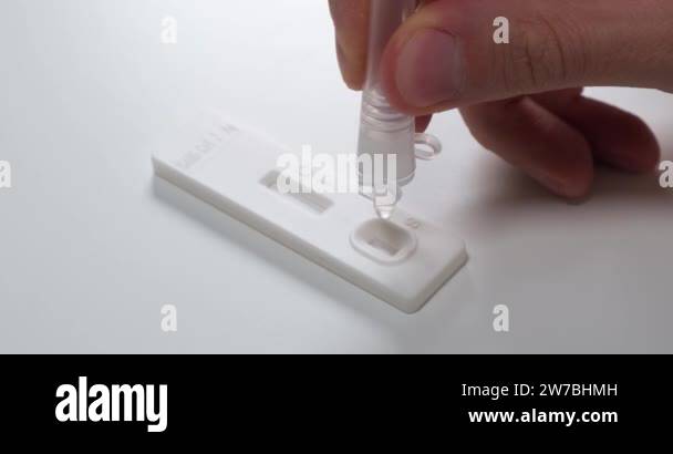 Process of taking rapid antigen self test with nasal swab, pouring ...