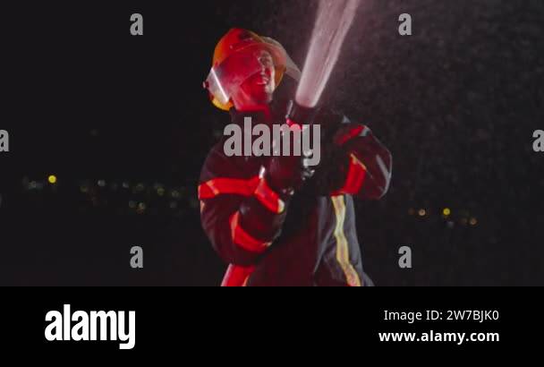 Fireman male and female group using water for fighting with fire flame ...