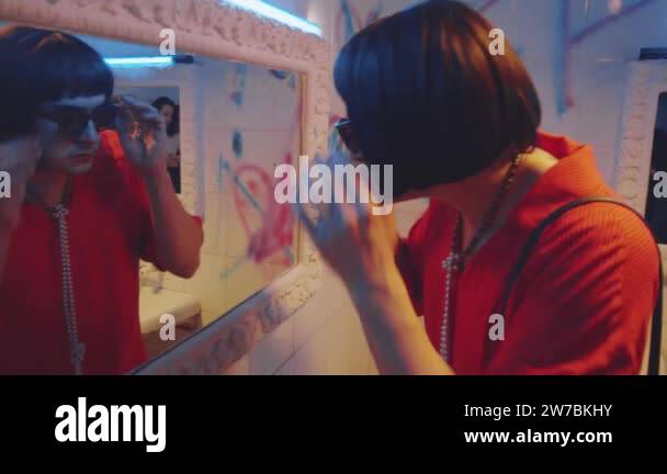 Transgender man in brunette wig and female outfit entering nightclub ...