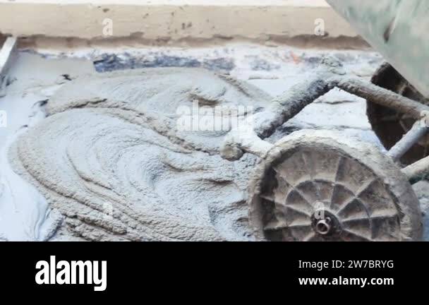 Cement mixer machine detail's dumping the fresh mixture on the floor in ...