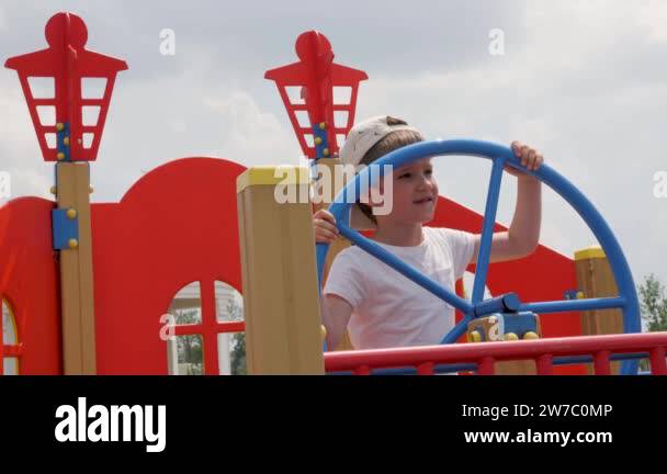Child captain at helm boat playground wooden ship in park game pirate ...