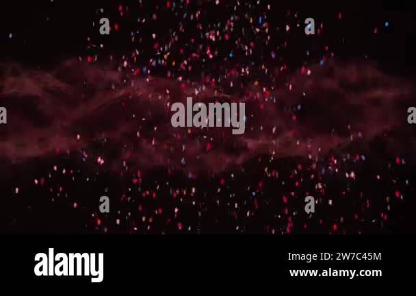 Animation of colourful confetti falling over red cloud moving on black ...
