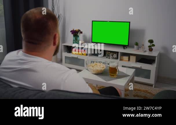 Man Watching Green Screen TV at home. Drink Beer Eating Popcorn. Over ...