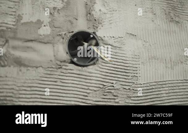 Wires sticking out of a socket for a socket in a concrete wall Stock ...