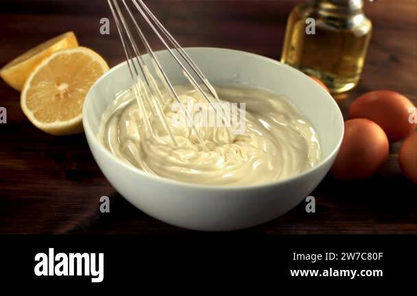 Super slow motion cooking fresh mayonnaise at home. Filmed on a high ...