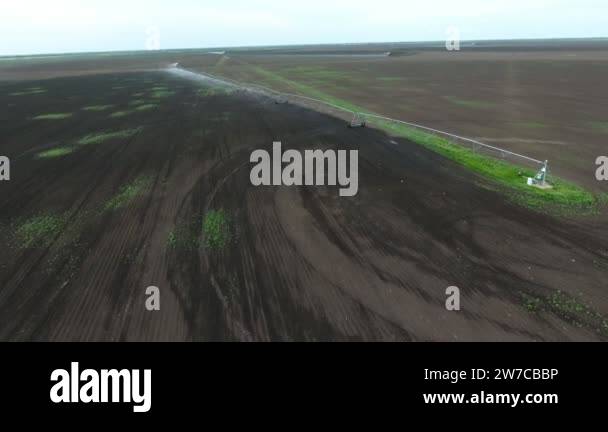 Aerial shot of straight irrigation machine with a water pump shooting ...