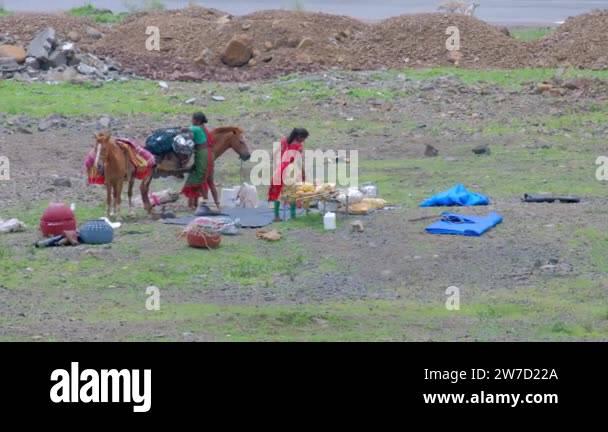 Female gypsies winding up camp in an open field at Pune India Stock ...