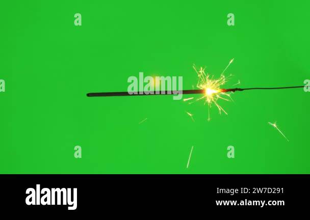 Burning bengal fire and sparks on green background in vertical in 4K ...