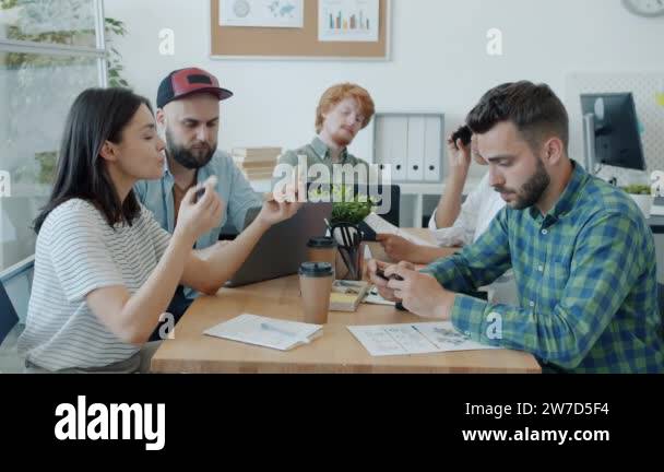 Lazy bored employees playing mobile games flying paper planes and ...