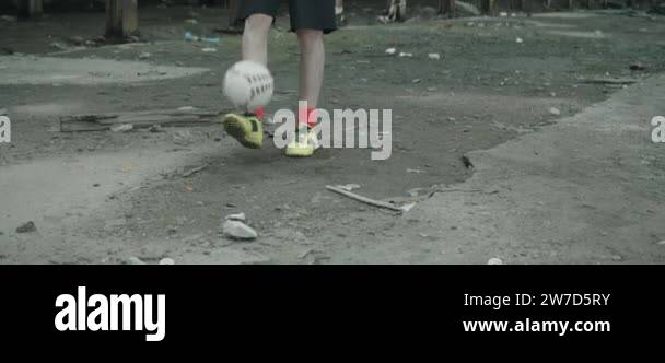 Anamorphic tilt up shot of male football athlete juggling soccer ball ...