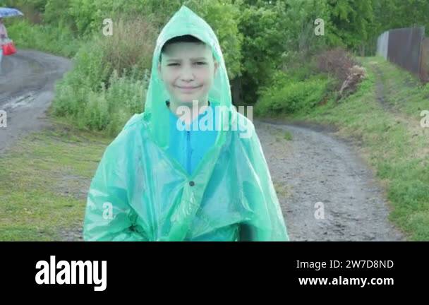 Boy in the rain. dressed in a raincoat. Portrait of a boy in the rain ...