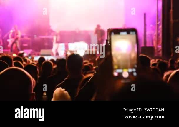 People Filming Rock Concert on Smartphones, Silhouettes Crowd of Fans ...
