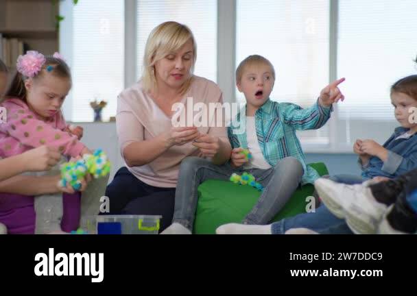 female teacher conducts developmental therapy with kids with ...