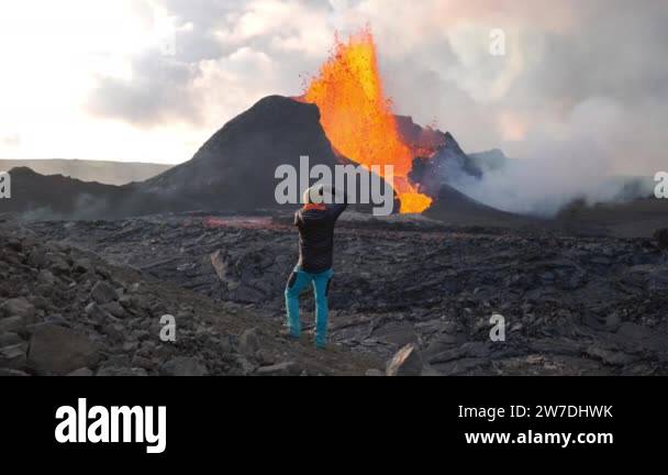 Man Photographing Lava Flowing From Erupting Fagradalsfjall Volcano ...