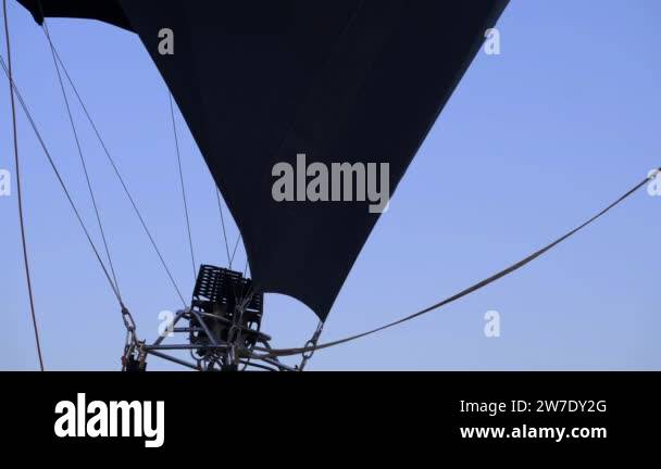 A Man Lifts Up A Huge Balloon At A Balloon Festival. Blowing Up Hot Air ...