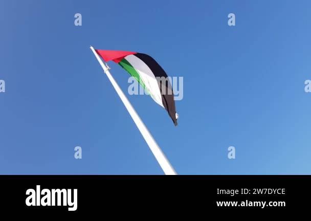 UAE flag waving in the sky, national symbol of UAE. UAE National Day ...