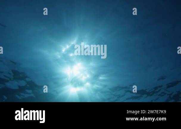 Underwater Godrays effect. Sun beams penetrating wavy ocean surface ...