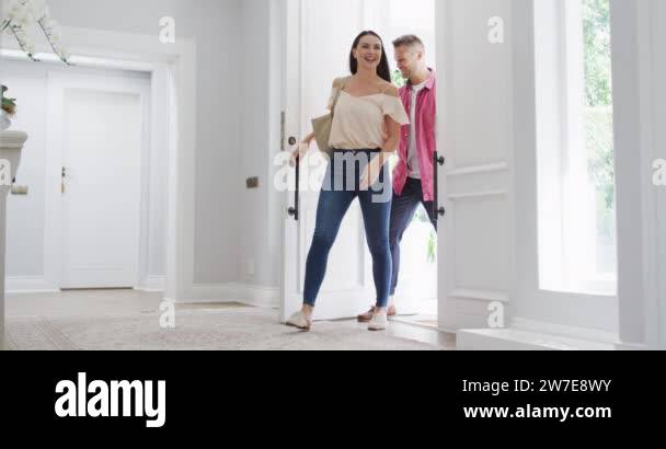 Excited caucasian son at home running to greet his smiling parents ...