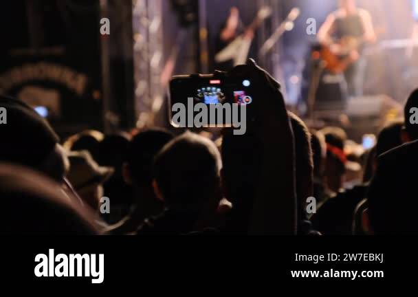 People Filming Rock Concert on Smartphones, Silhouettes Crowd of Fans ...