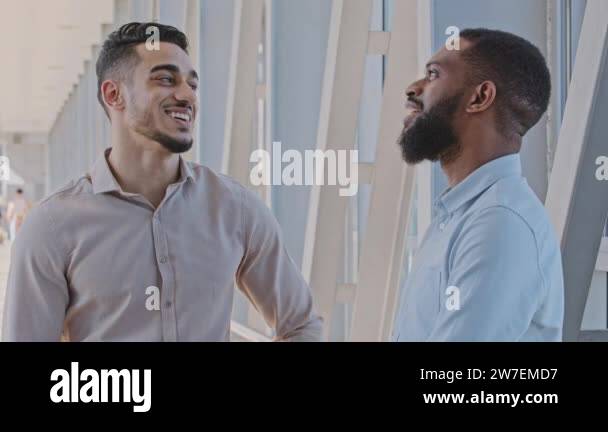 Two multiracial colleagues business men african american guy and ...