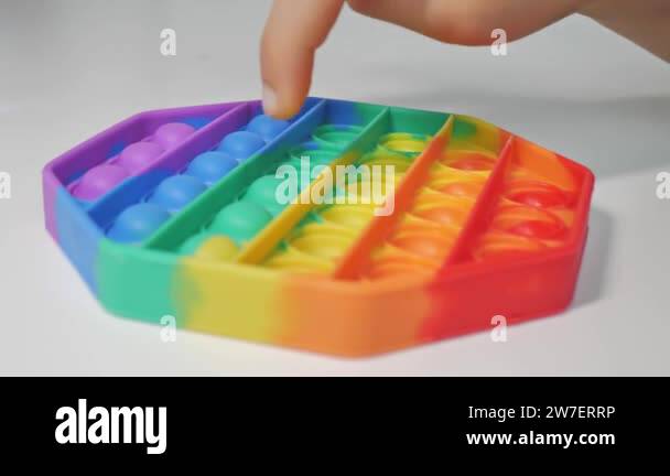 clicks on the toy Pop It Fidget. side view Stock Video Footage - Alamy
