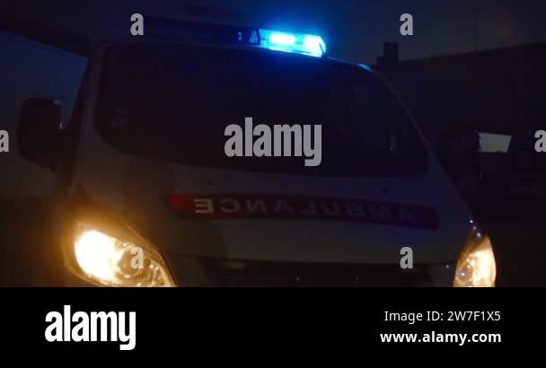 Ambulance car with blue lights at street in dark evning. Paramedical ...