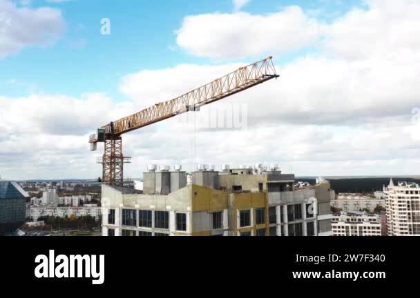 Drone flying close around construction crane during development process ...