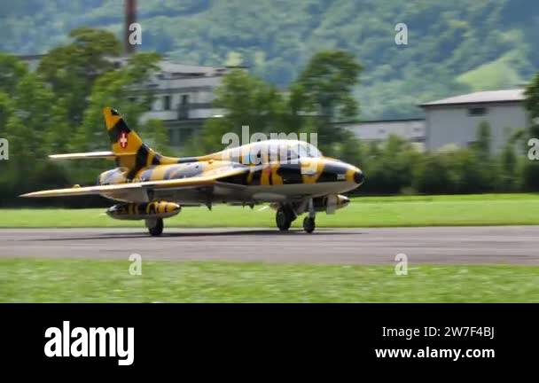 Takeoff of a cold war military fighter jet with yellow and black livery ...