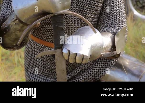 A knight in a full set of medieval armor and with a bandana on his head ...