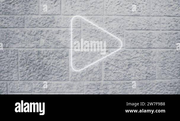 Animation of neon play button flickering with copy space over wall ...