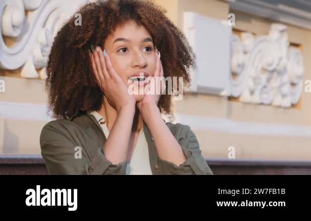 Happy young attractive African American female tourist with curly hair ...