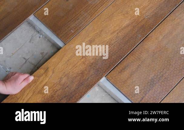 Repair home deck floor of wood panels connecting. Carpenter sets deck ...