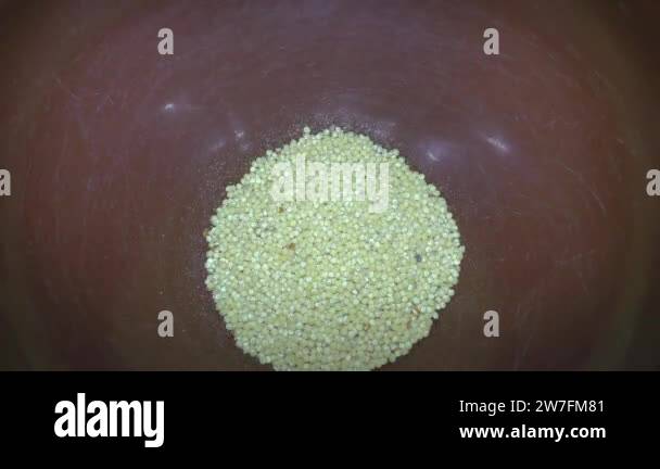 Preparation of millet porridge in a ceramic pot. Millet porridge with ...