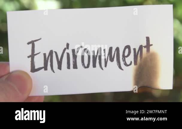 Burning the word Environment written on a piece of paper, concept of ...