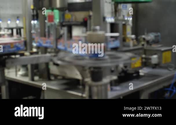 Blurry video of the machine working on the label sticker on a plastic ...