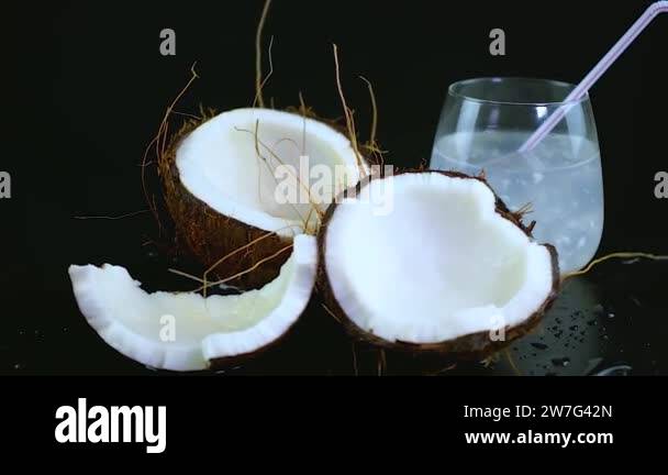 Rotation of coconut shell and white flesh, glass of milk water straw ...