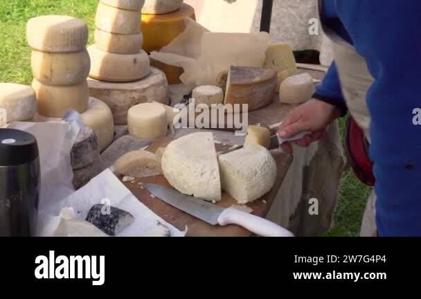 A farmer sells at a farmers market of fresh and aged goat cheese. Goat ...