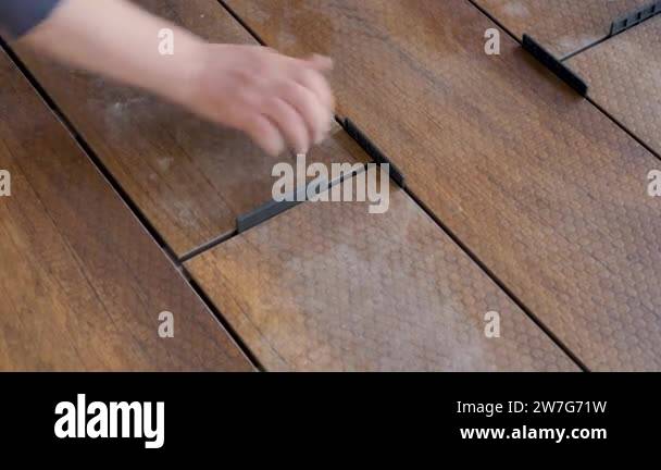 Carpenter sets spacing of deck boards on floor wood panel. Flooring ...