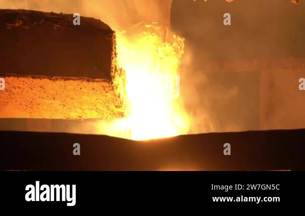 From the blast furnace, molten liquid metal is poured down the chute ...
