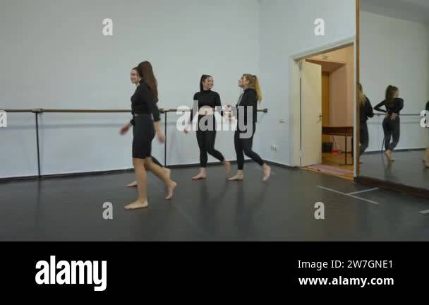 Live camera follows group of beautiful slim young women entering dance ...