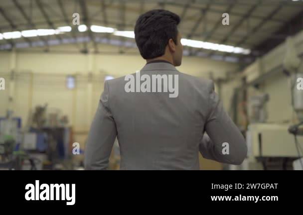 Young 20s Indian Asian factory business owner in formal suit walking ...