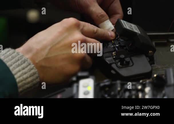 Worker welds optical line internet wire with welding machine. Service ...