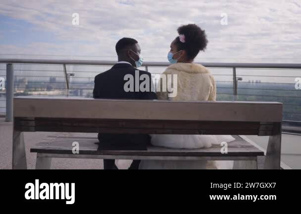 Back view of African American newlyweds in coronavirus face masks ...