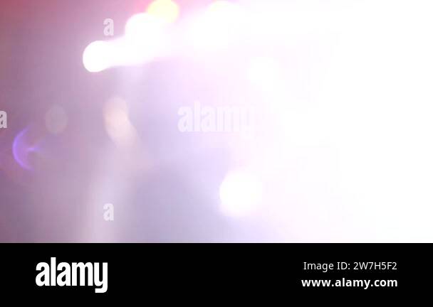 Neon lights on the dance floor. Slow time. Blurry bokeh. People are ...