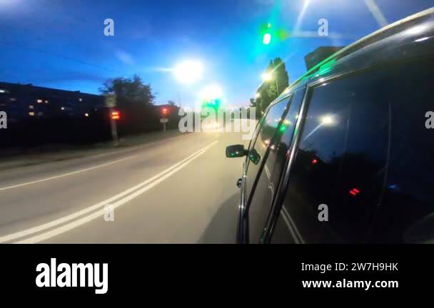 Black suv driving on city highway at night. Auto riding through town ...