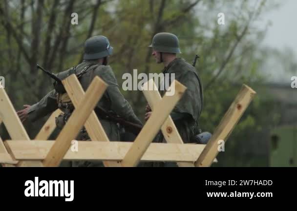 2 Wehrmacht soldiers in German army uniform are talking to each other ...