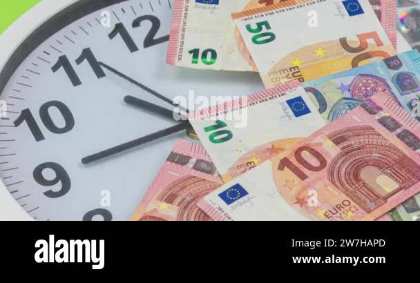 Clock face time lapse on green background with money on the clock ...